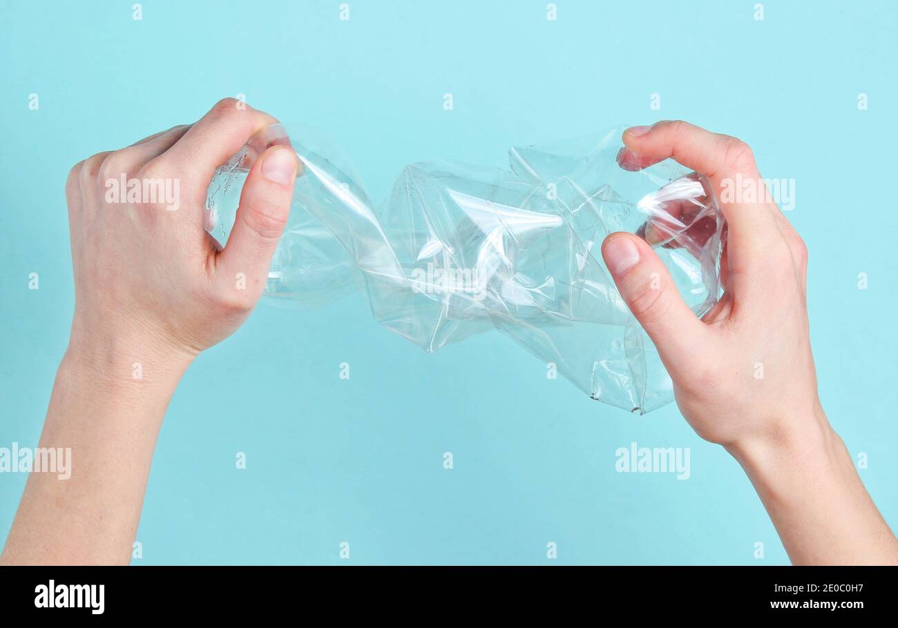 Minimalistic pollution ecology concept. Female hands twists rumpled ...