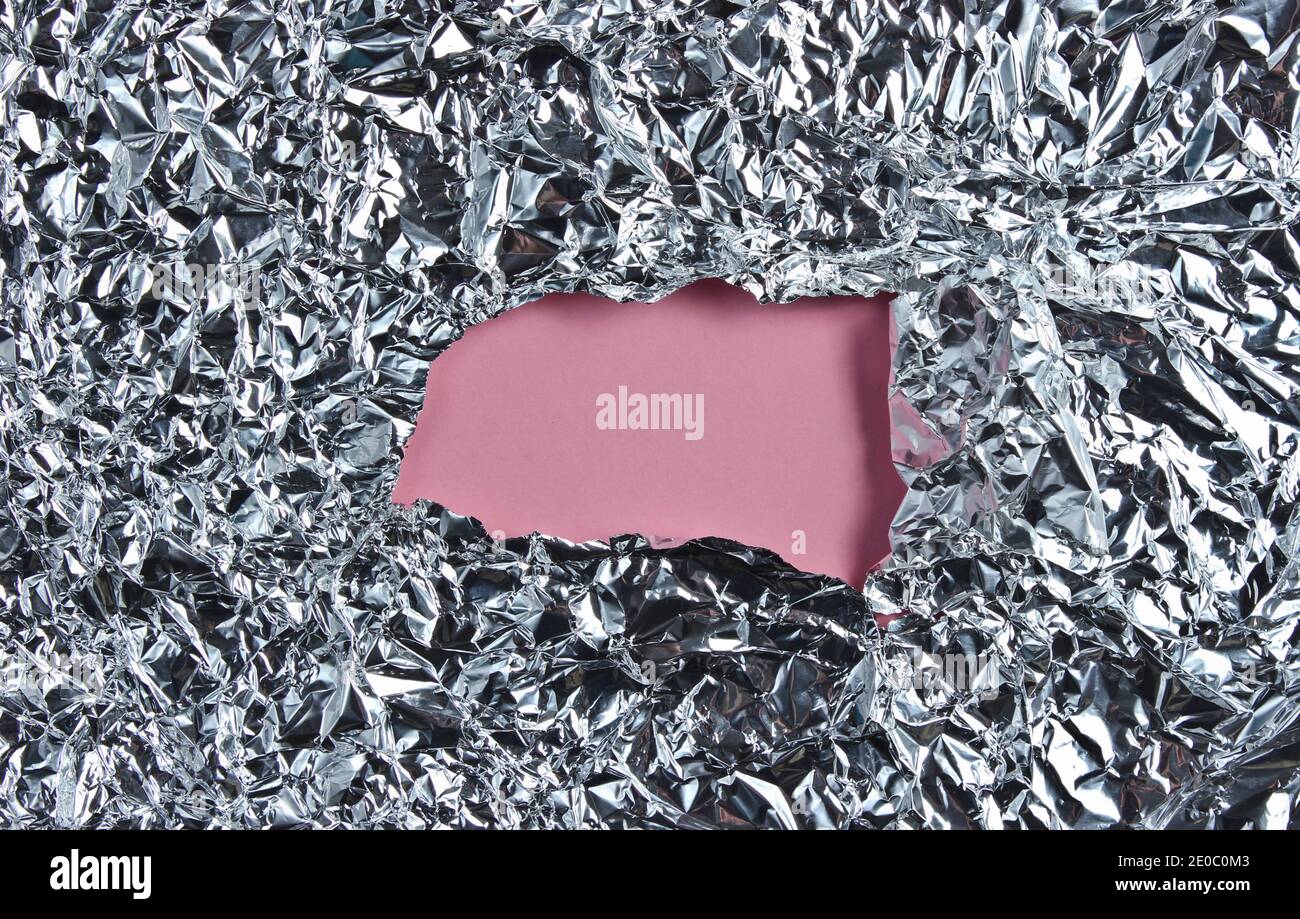 Torn Frame of crumpled foil with pink space for infirmation. Copy space ...