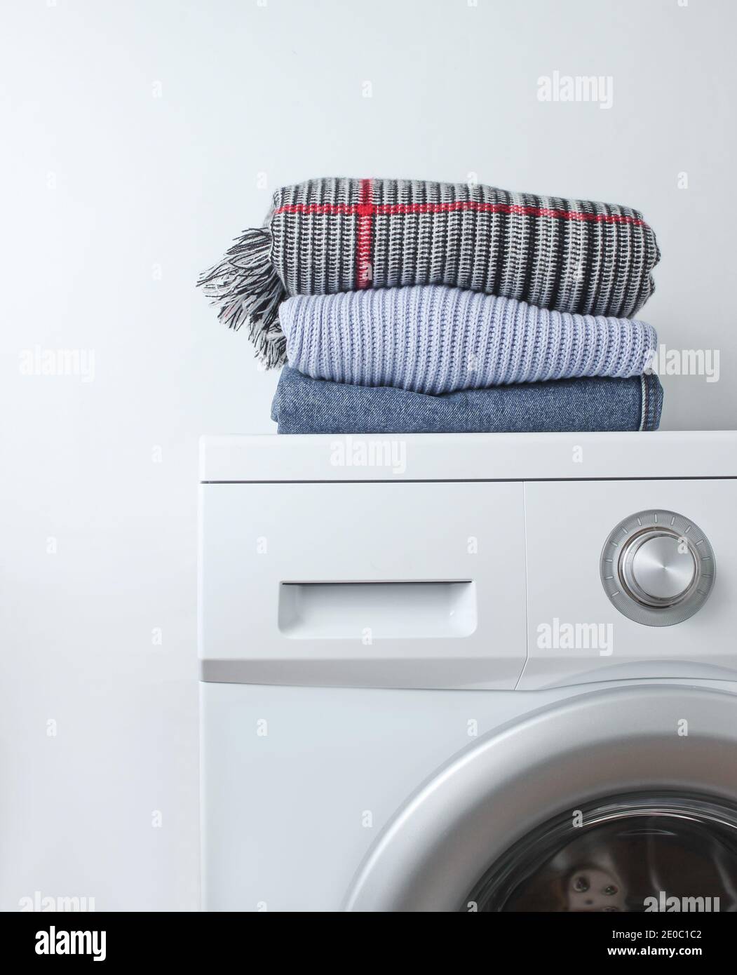 Stack of clothes on washing machine against a white background Stock ...