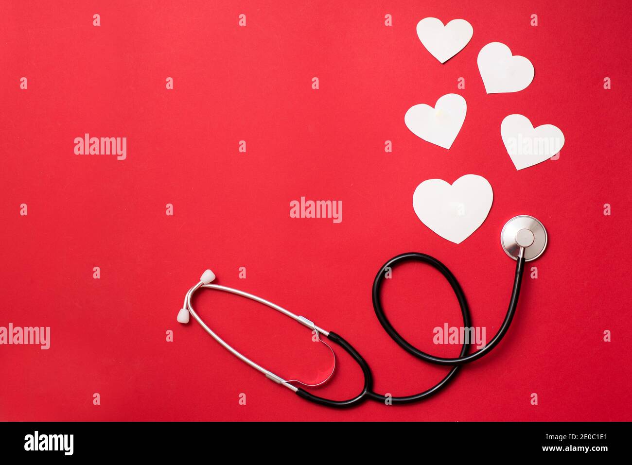 hearts and stethoscope , heart health care concept, red background with ...