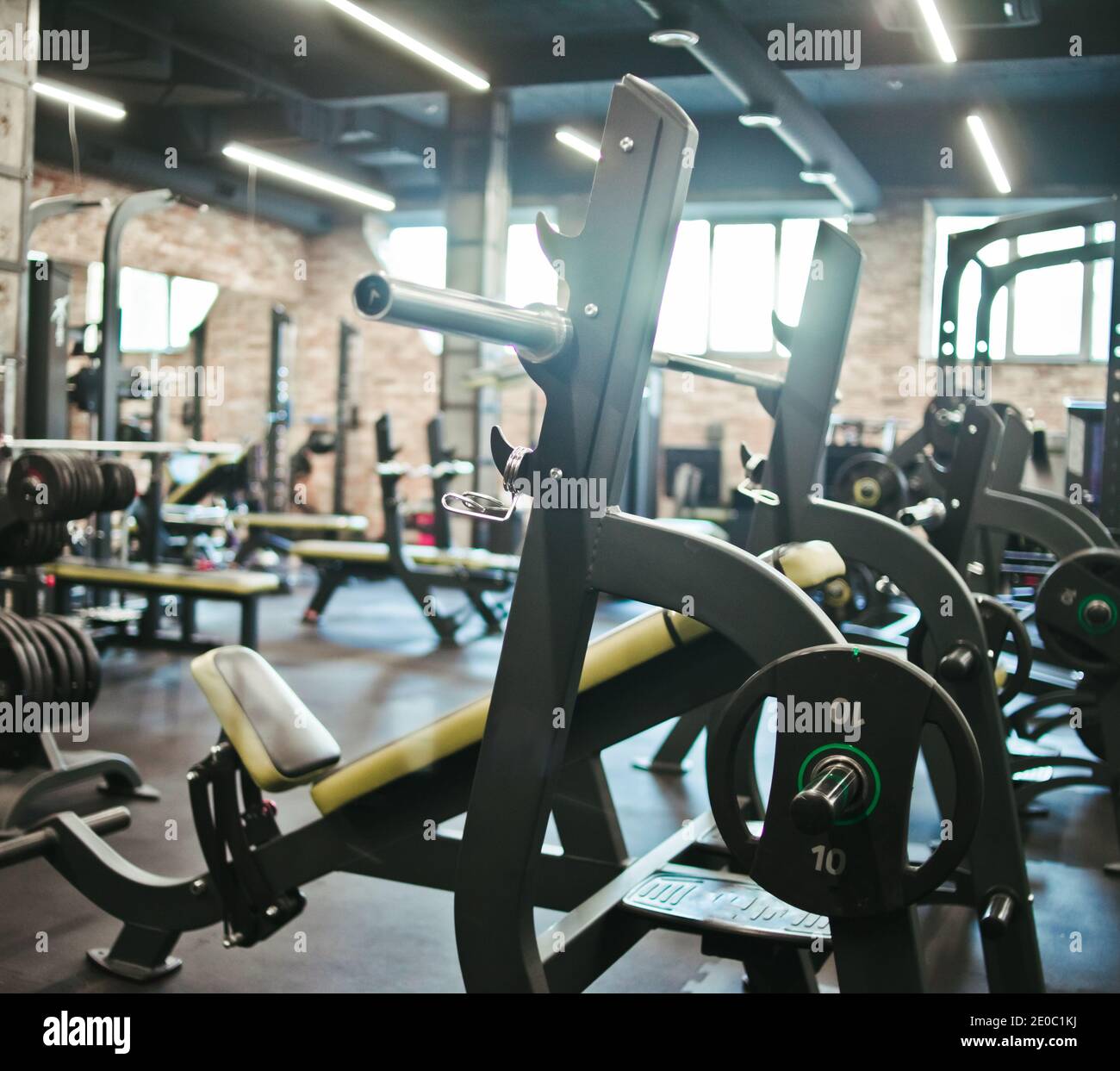 Inclined bench, barbell on racks on the background of the gym Stock ...