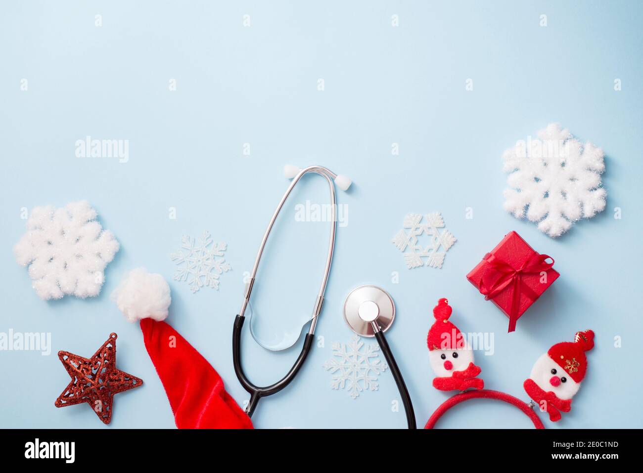 Christmas medicine blue background with stethoscope and new year red ...