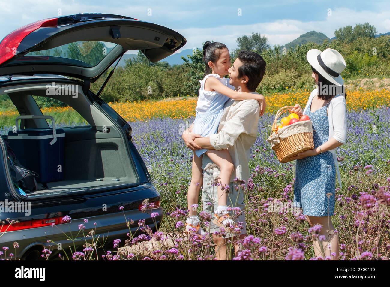 Happy three stand in the flower sea Stock Photo - Alamy