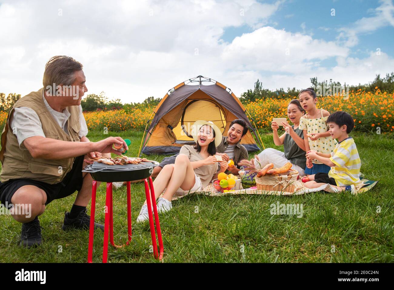 A happy family in the suburbs of barbecue Stock Photo - Alamy