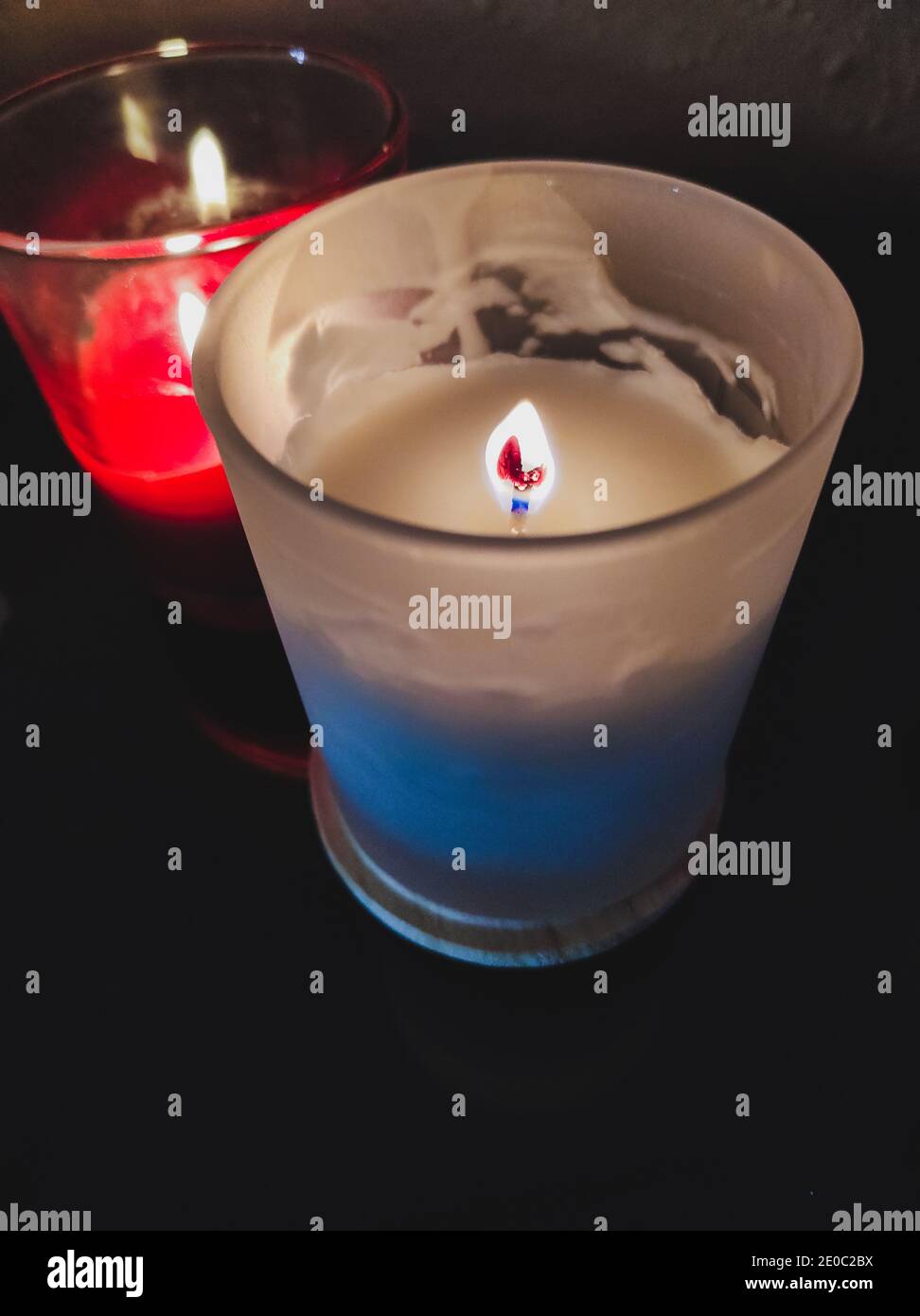 Close up of used candles with flames Stock Photo - Alamy