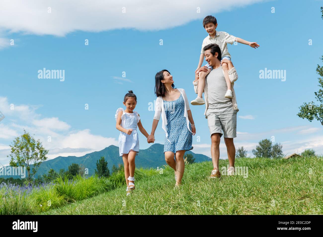A family of four in outside for a walk Stock Photo - Alamy