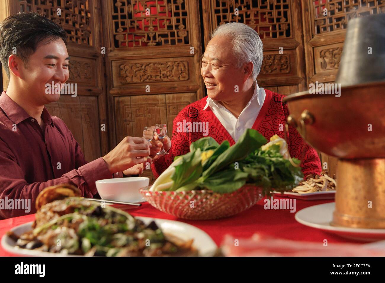 Happy father and son eat dinner drink Stock Photo - Alamy