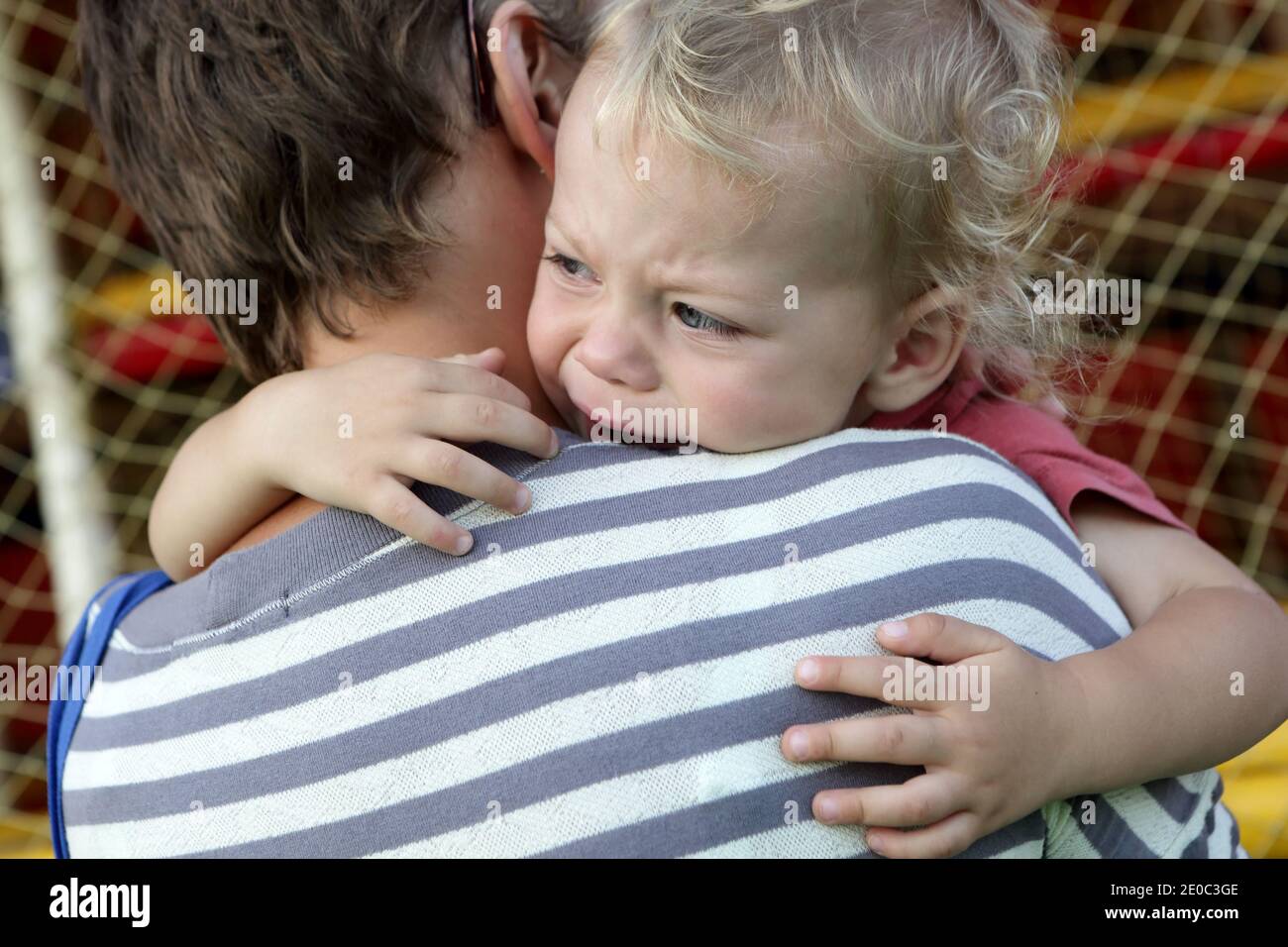 Child crying on mother shoulder in summer Stock Photo - Alamy