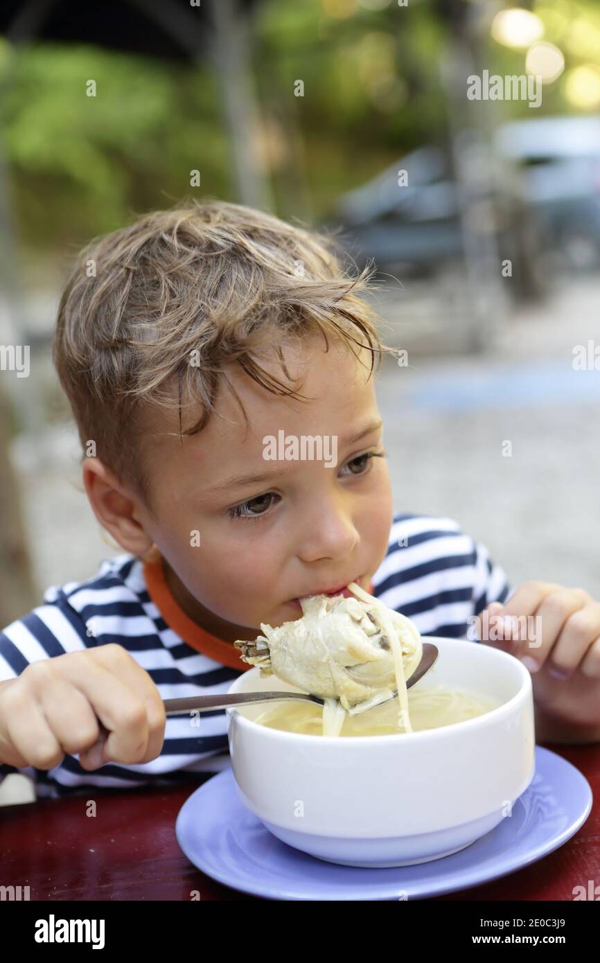 Boy eating soup for lunch in a cafe hi-res stock photography and images ...
