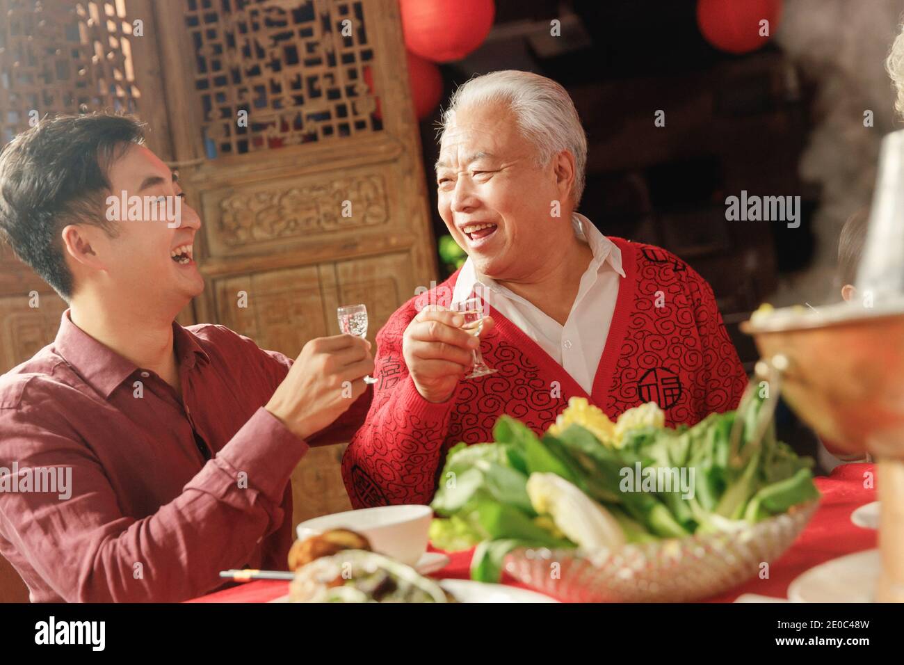Happy father and son eat dinner drink Stock Photo - Alamy