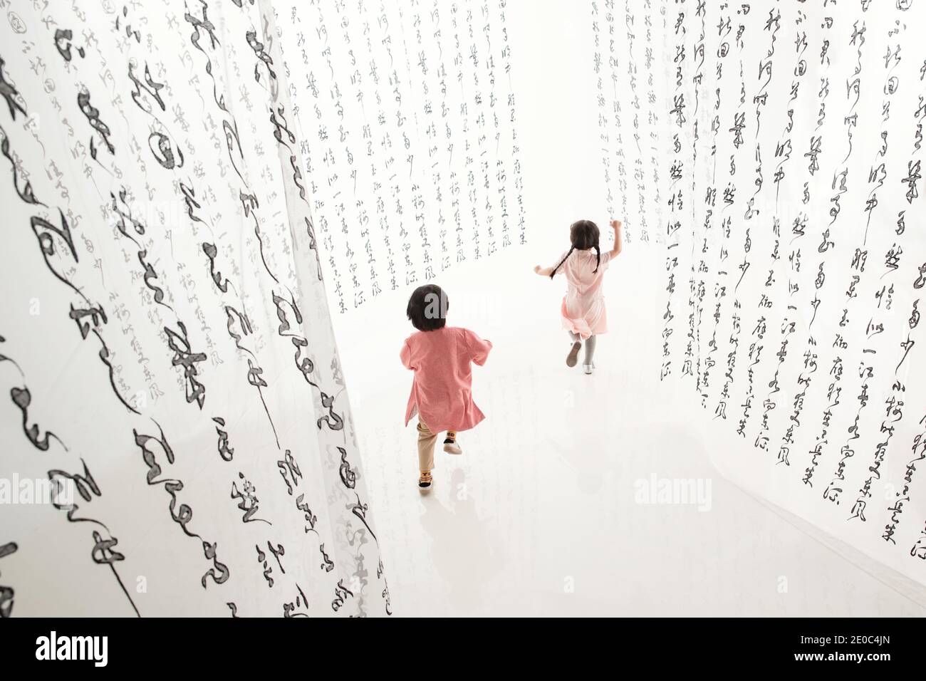 Happy boys and girls run back playing Stock Photo - Alamy