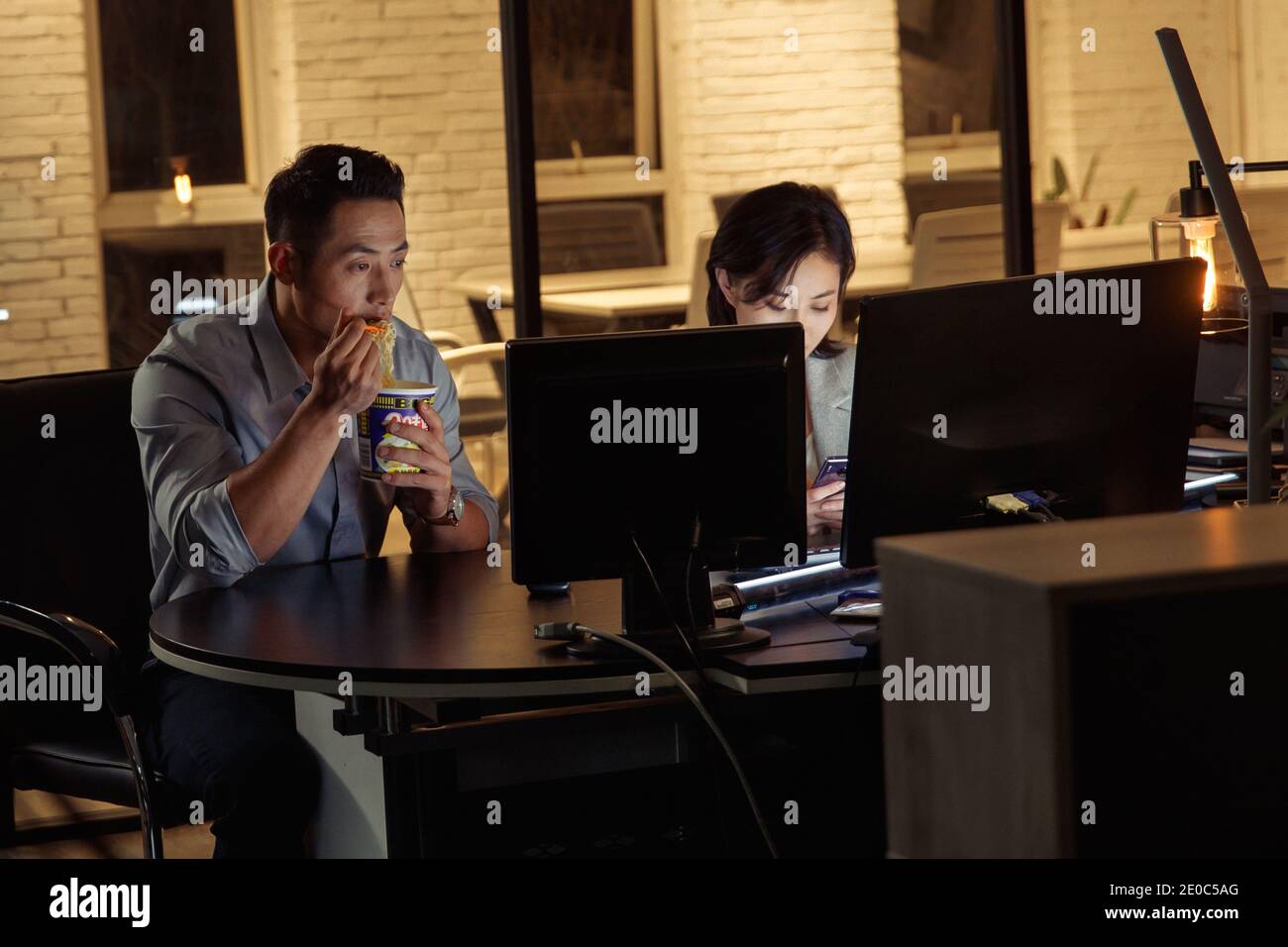 Business people in the office to work overtime Stock Photo - Alamy