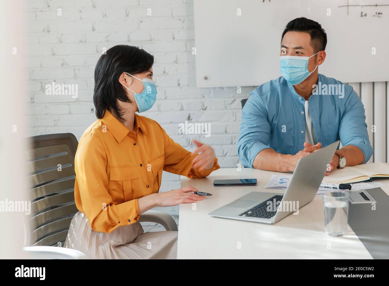 Wearing a mask of business men and women in the conference room Stock ...