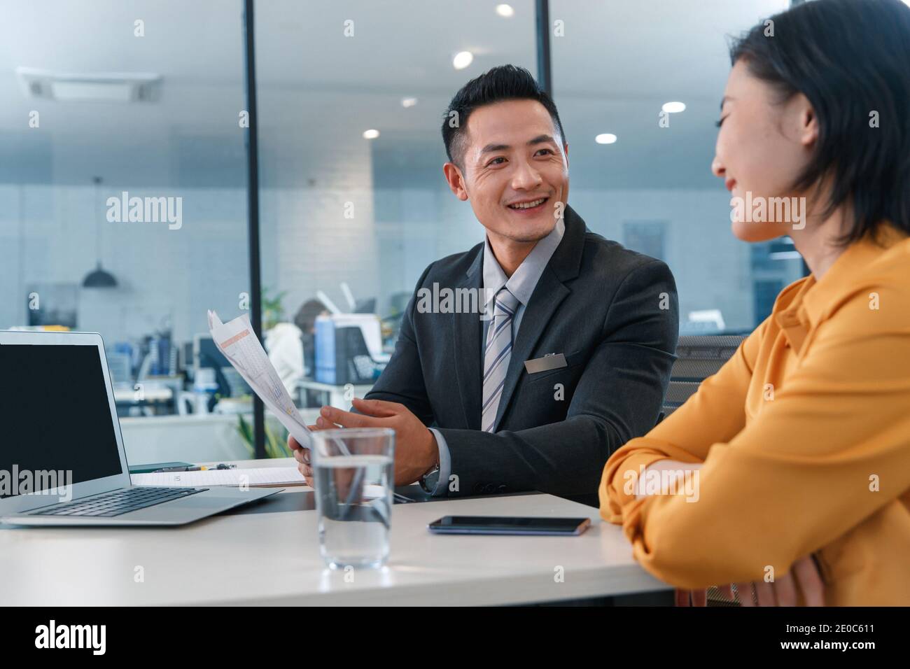 Sales staff with clients Stock Photo - Alamy