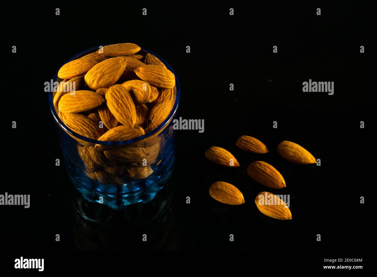 Protein-rich Raw Badam stacked in a glass on a dark table Stock Photo ...