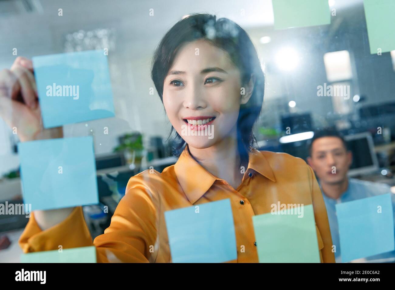 Business lady in the office to write on post-it notes Stock Photo - Alamy