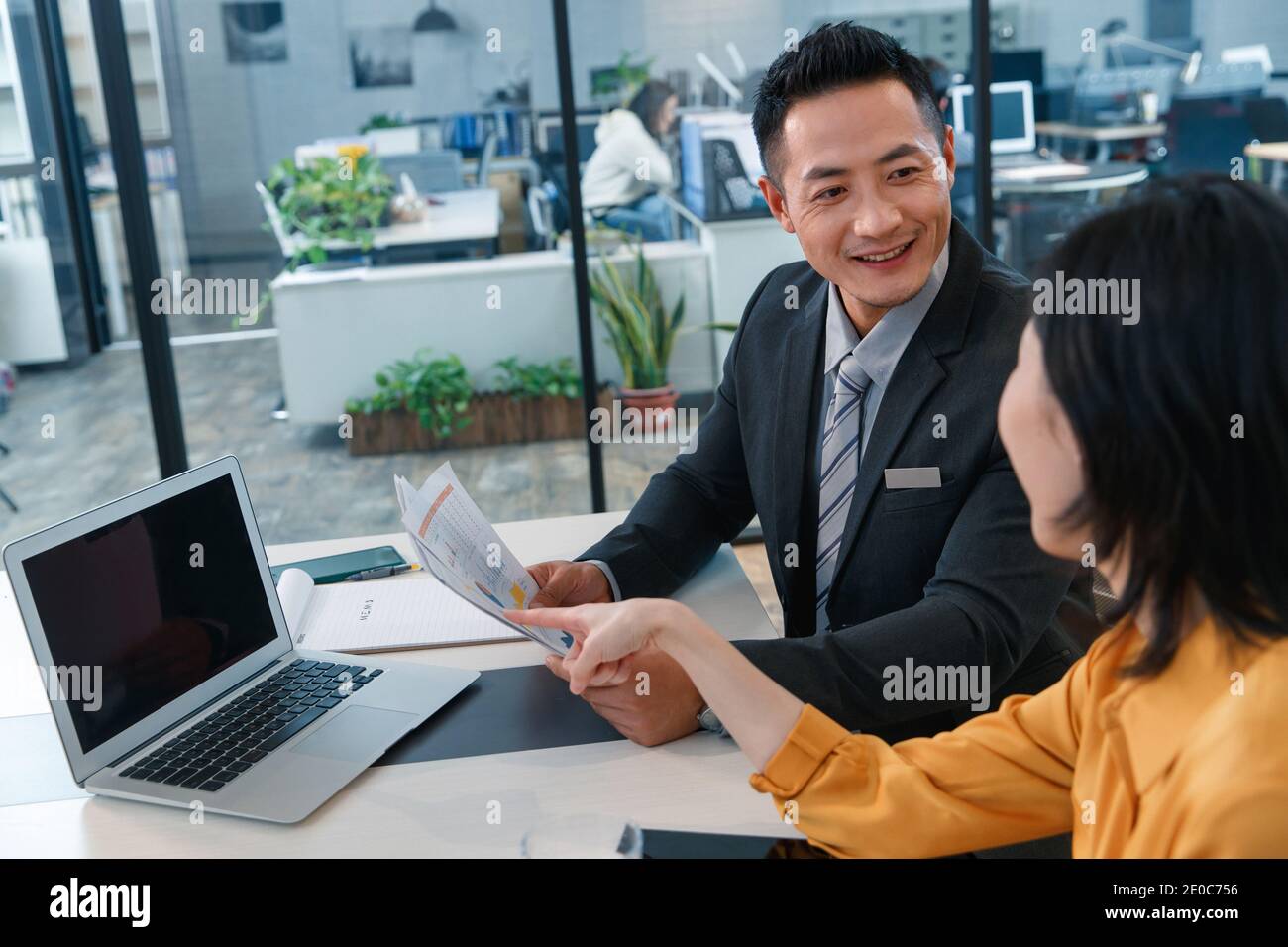 Sales staff with clients Stock Photo - Alamy
