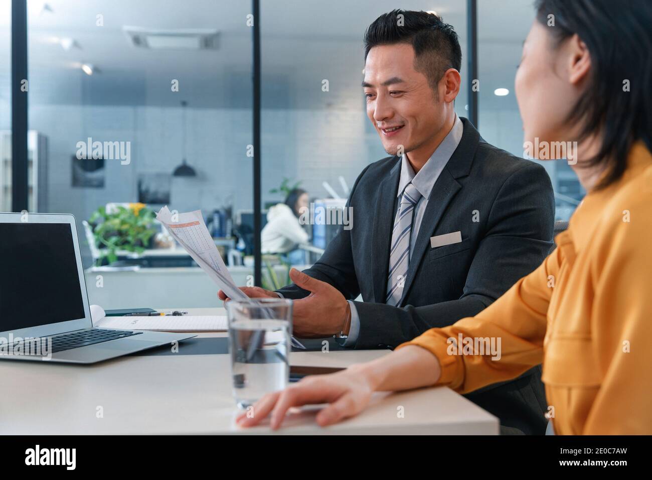 Sales staff with clients Stock Photo - Alamy