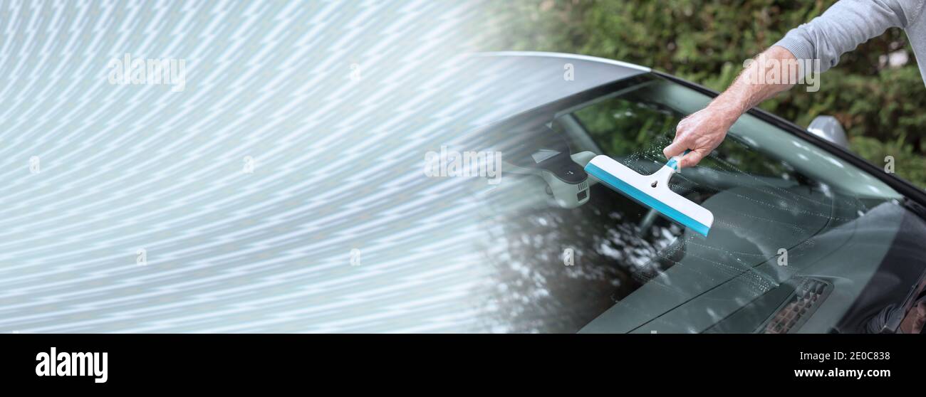 Man cleaning a windshield with a squeegee; panoramic banner Stock Photo ...