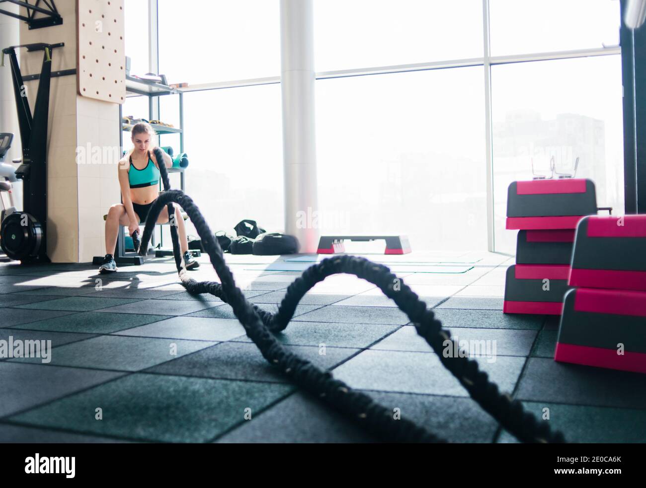 Strong young woman doing exercises for functional training in the gym ...