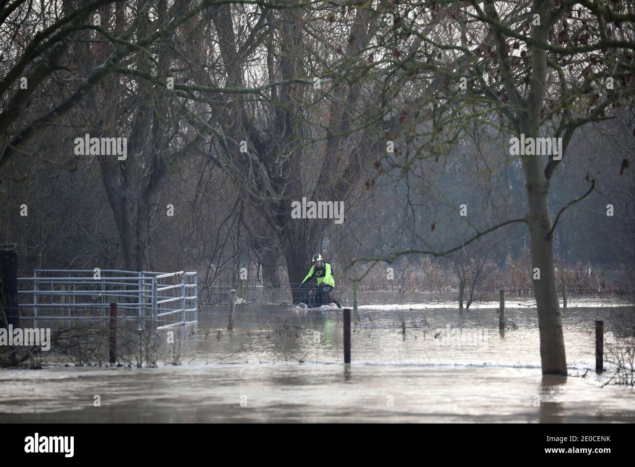 Peterborough, UK. 28th Dec, 2020. A cyclist makes his way along flooded ...