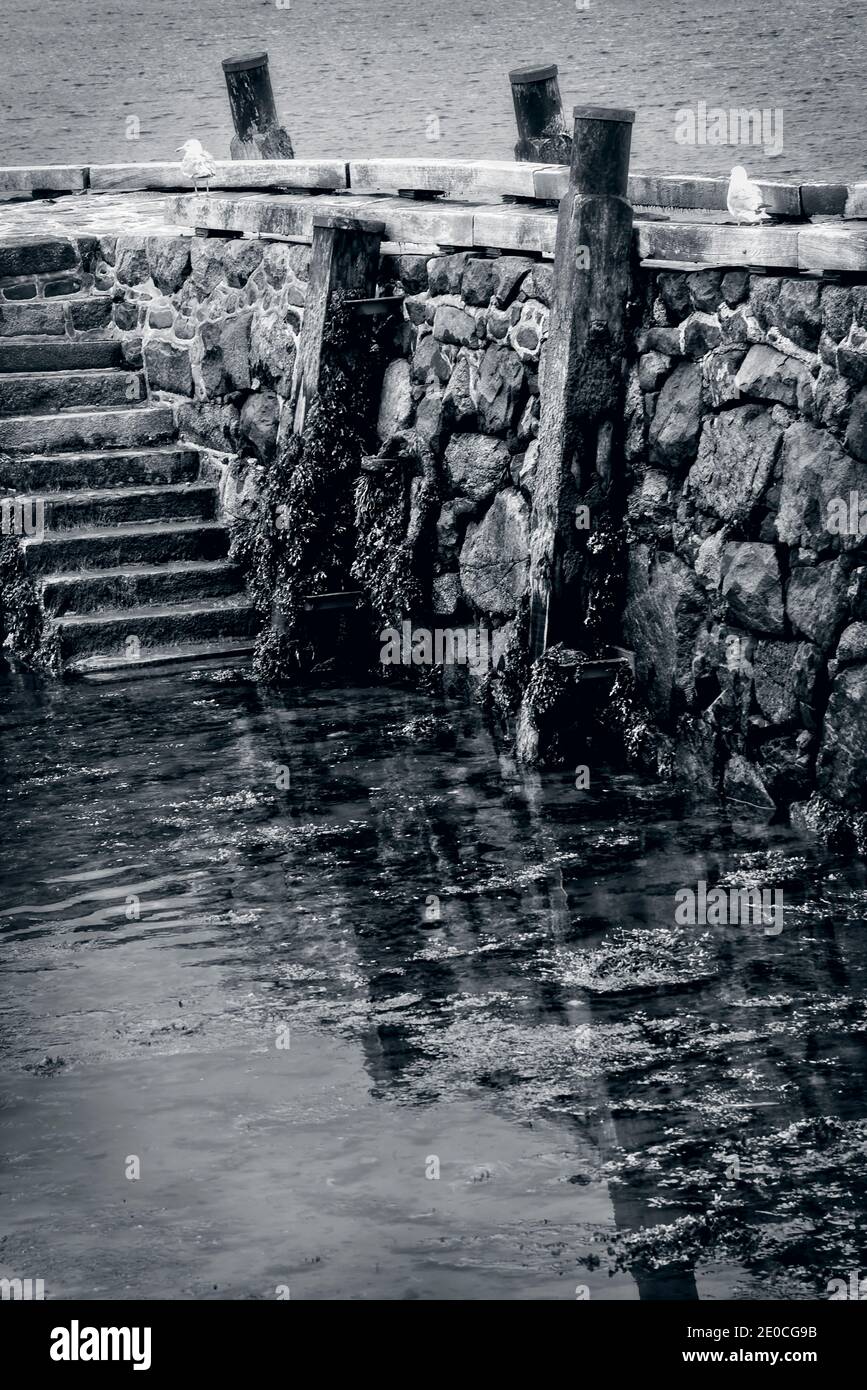Harbour wall with access steps Stock Photo - Alamy