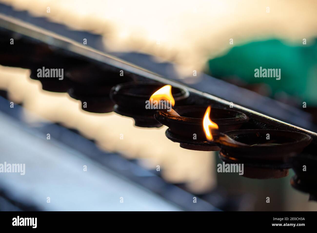 Burning clay oil lamps, glowing with the wind in the dark, offering ...