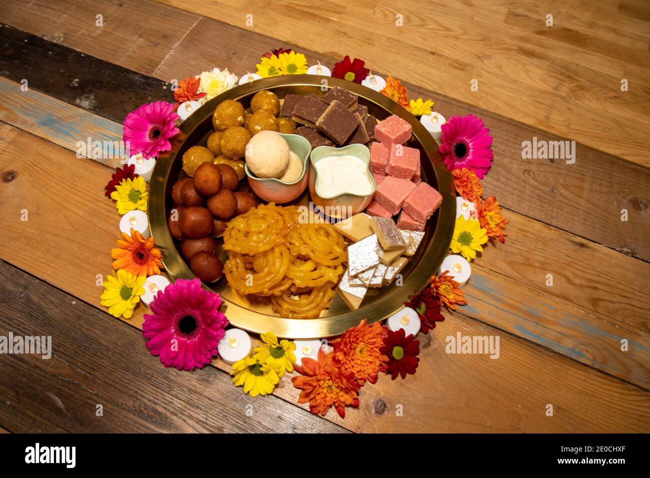 A trey of delicious Indian sweet treats on a wooden work top Stock ...