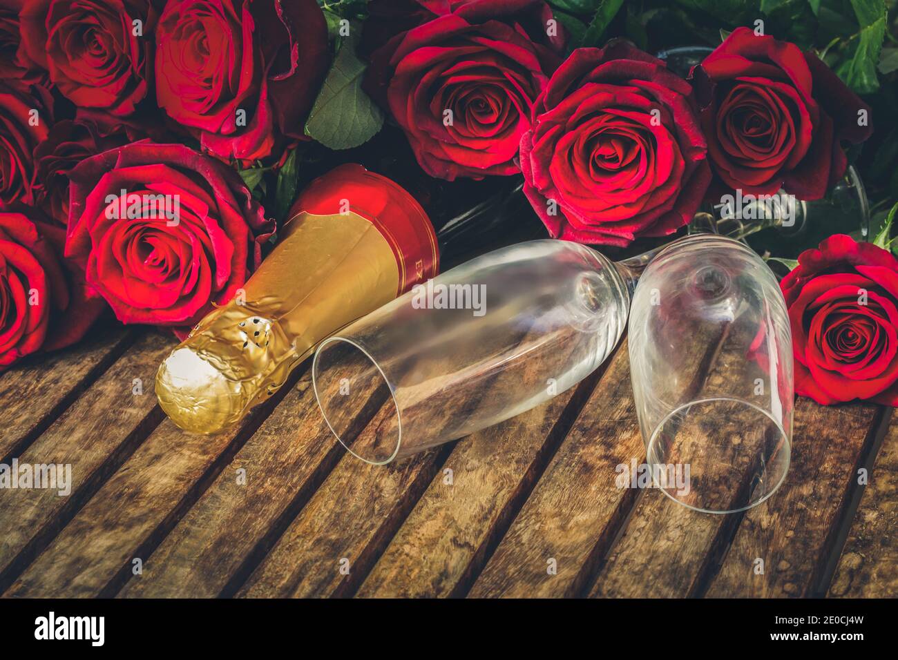 dark red roses with neck of champagne Stock Photo - Alamy