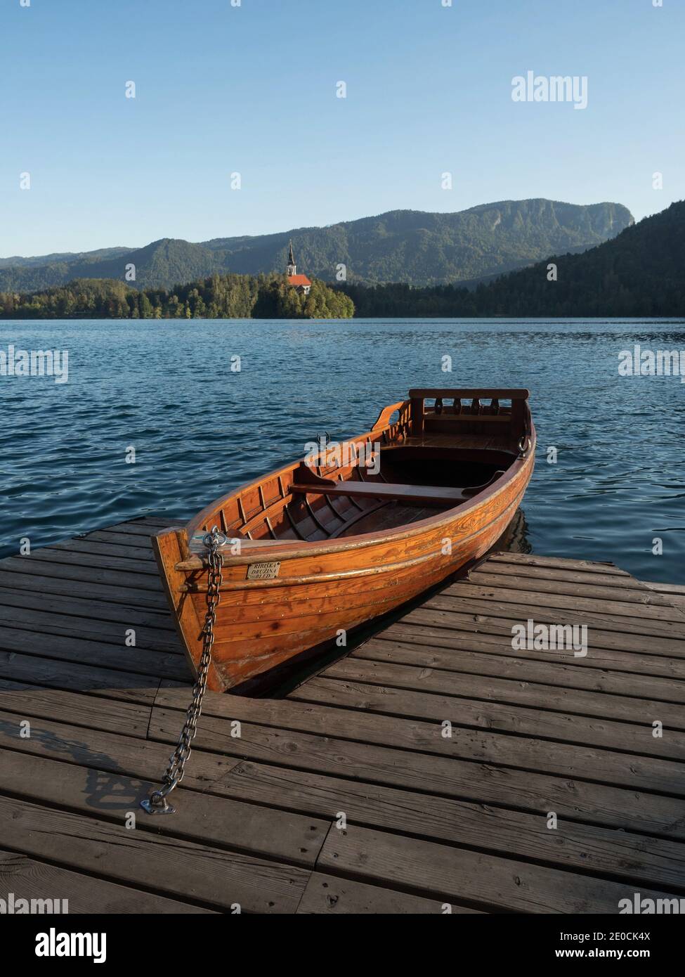 Wooden fisherboat canoe tourist paddle rowing watercraft at dock pier ...