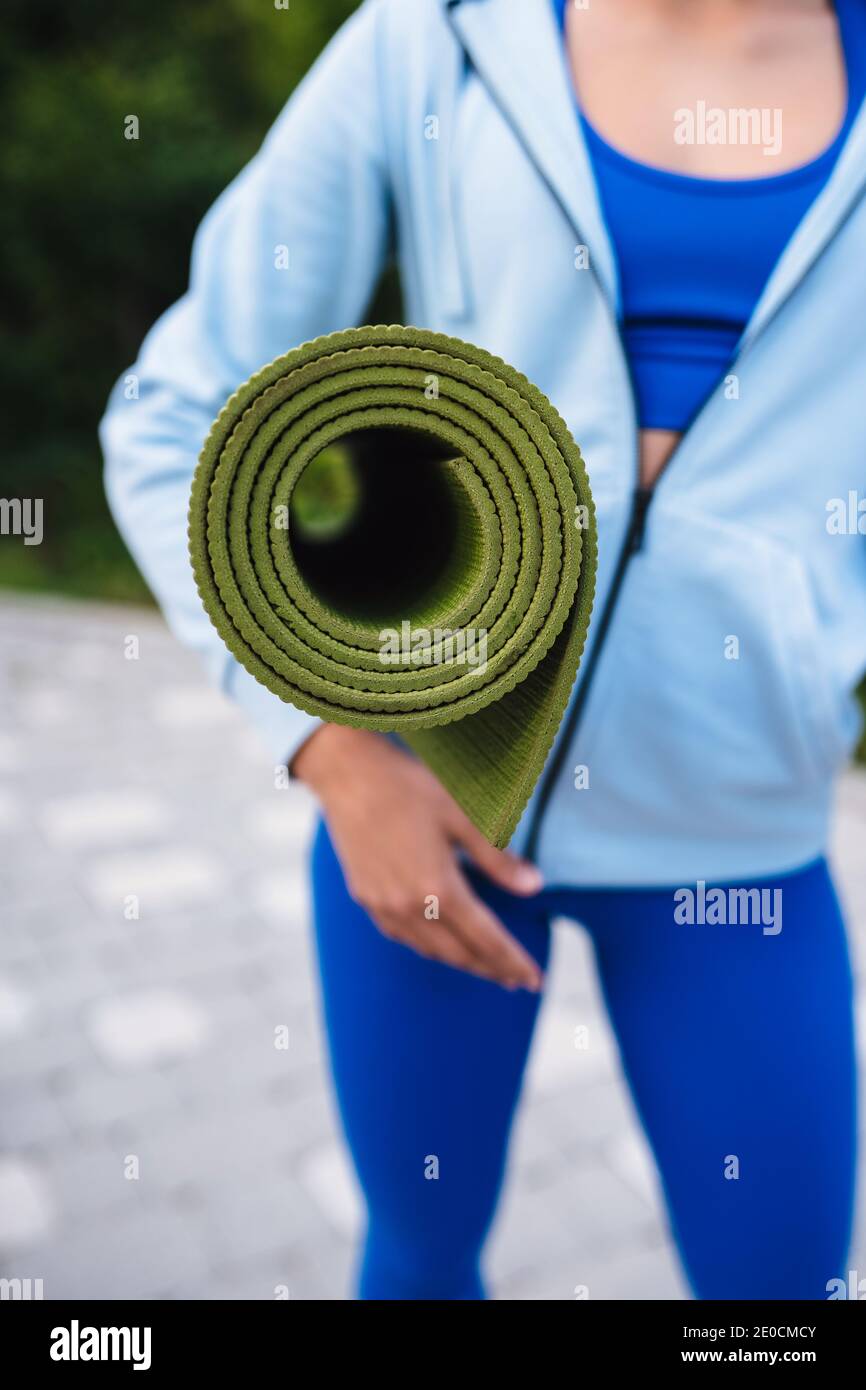 Close-up woman holding roll fitness after working Stock Photo - Alamy