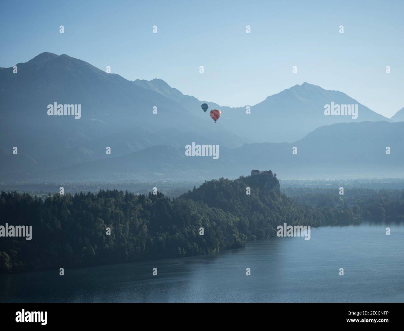 Panoramic view of hot air balloons over Lake Bled castle Blejsko jezero ...