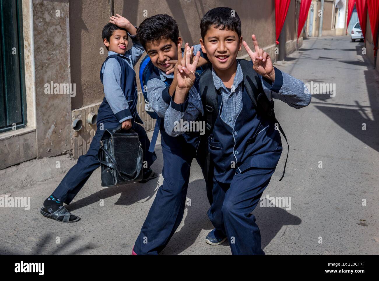 Iranian schoolboys acting on street in Kashan city, capital of Kashan ...