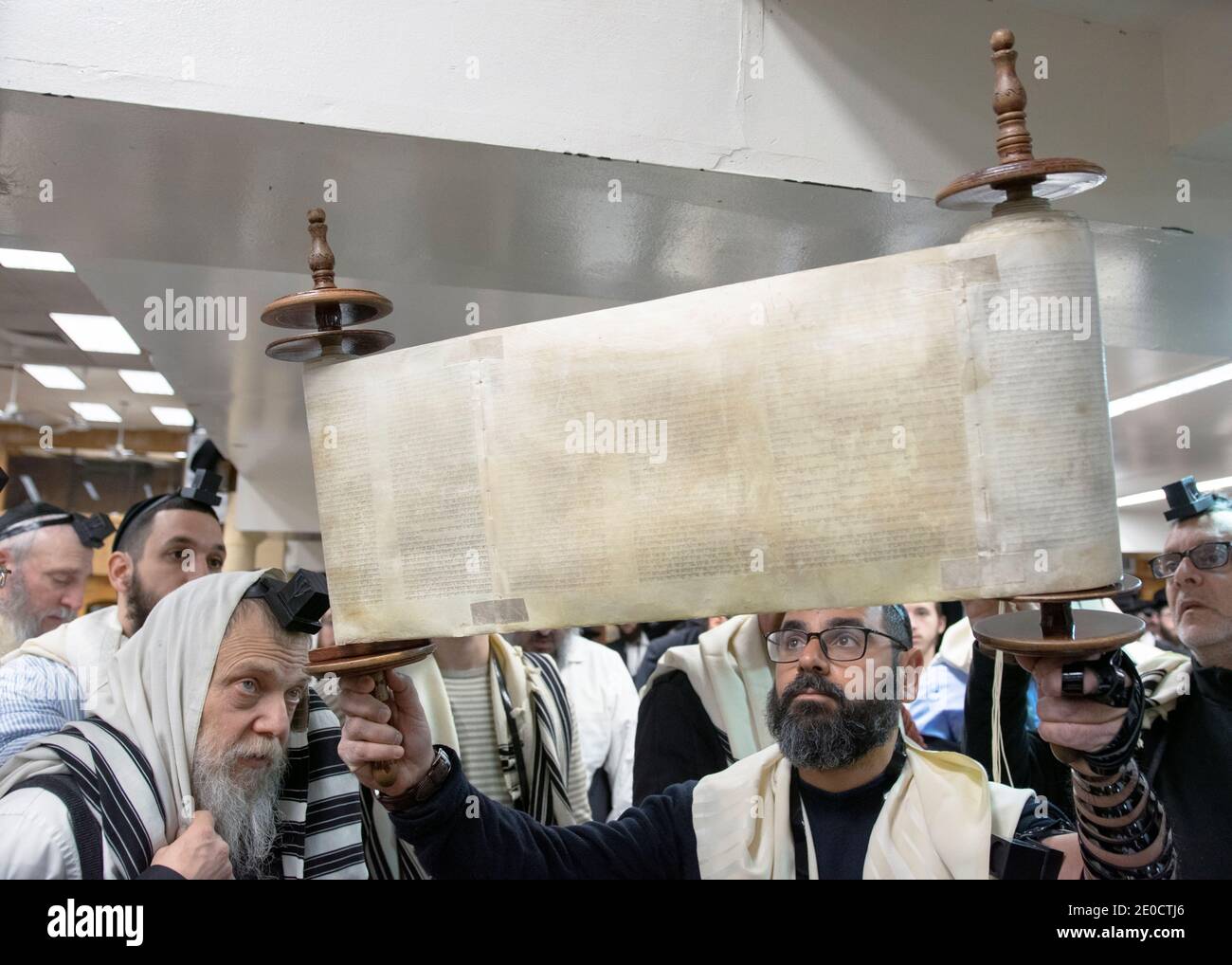 After a Torah reading at a synagogue, a man shows the letters of the ...