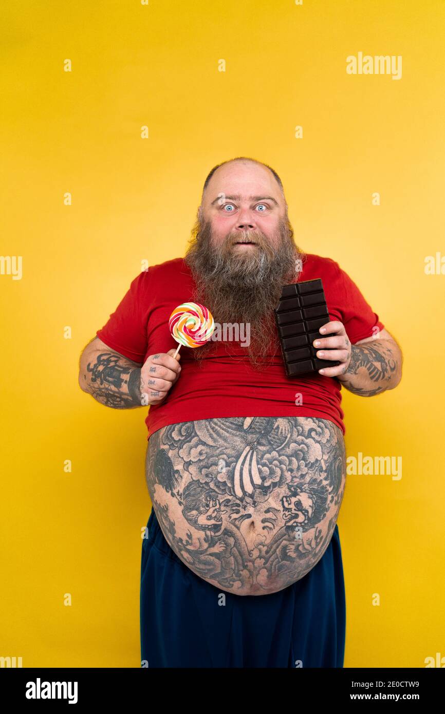 Funny and hilarious fat man hungry for unhealthy food Stock Photo - Alamy
