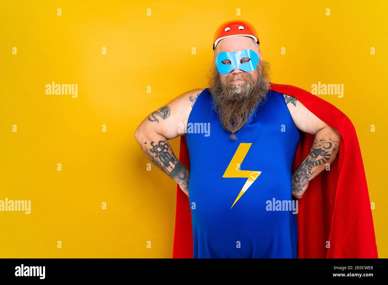 Funny fat man with superhero costume acting as superhuman with special ...