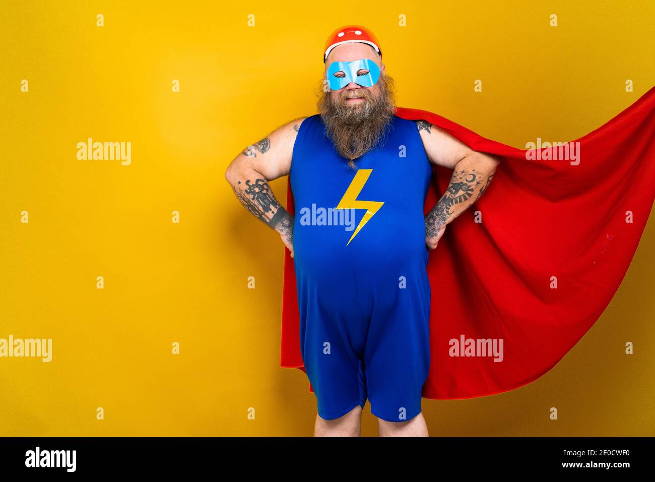Funny fat man with superhero costume acting as superhuman with special ...