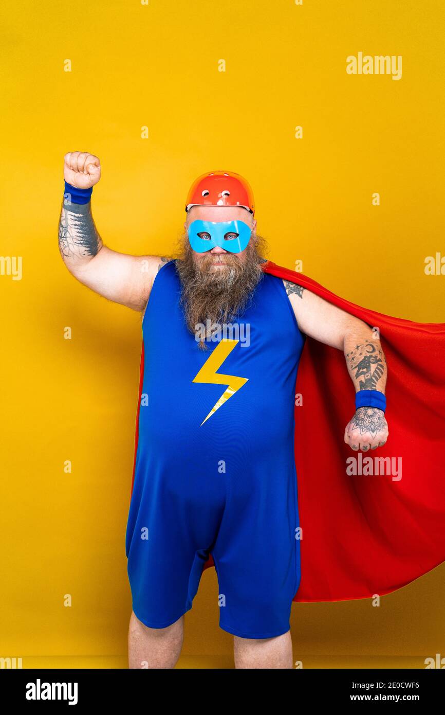 Funny fat man with superhero costume acting as superhuman with special ...
