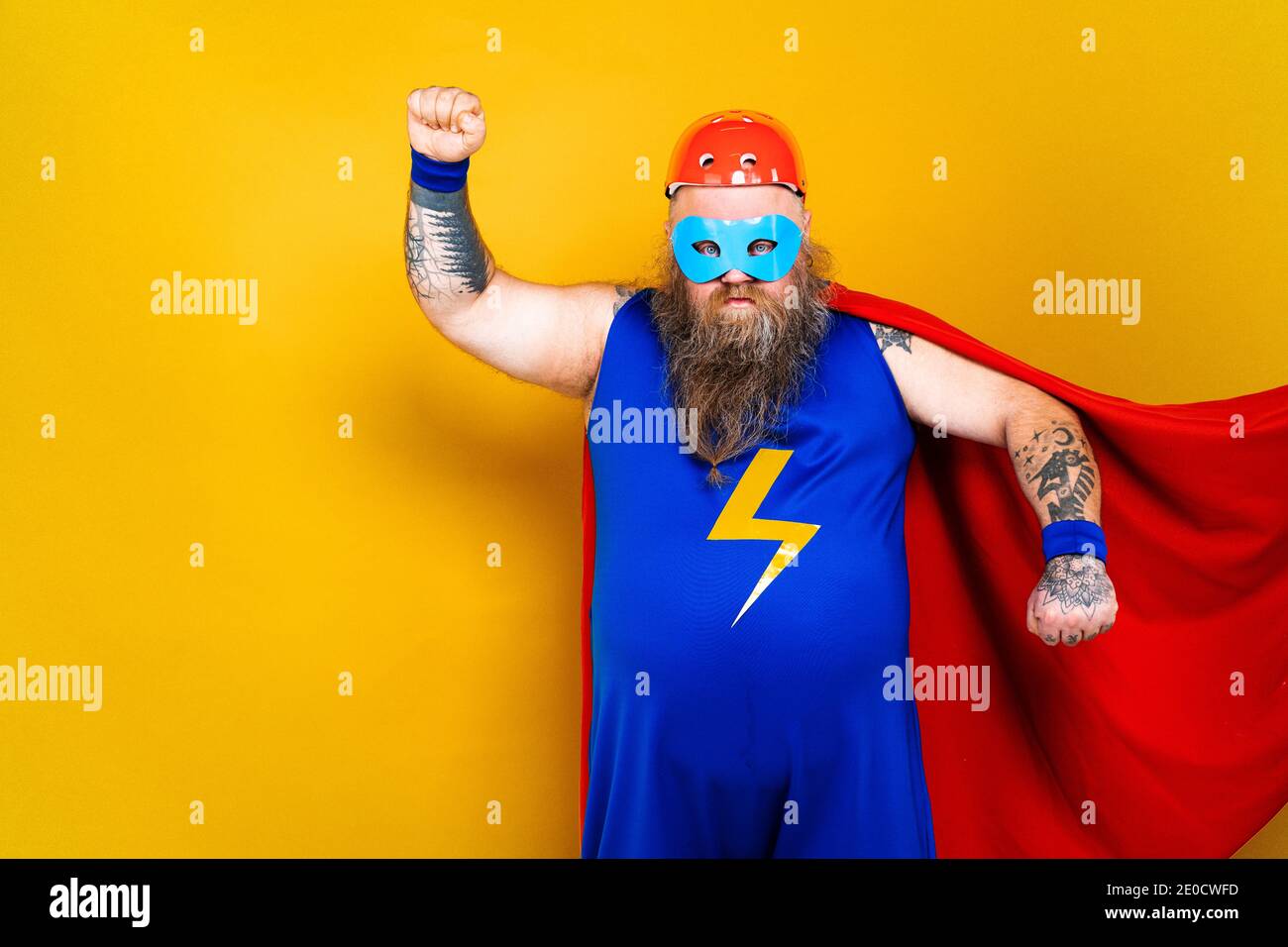 Funny fat man with superhero costume acting as superhuman with special ...