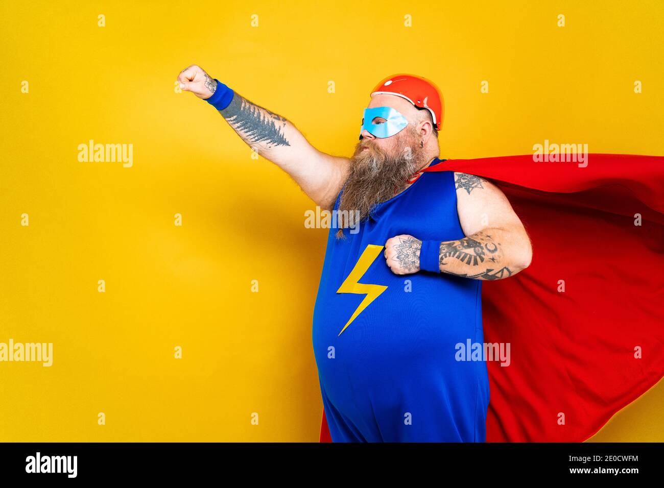 Funny fat man with superhero costume acting as superhuman with special ...