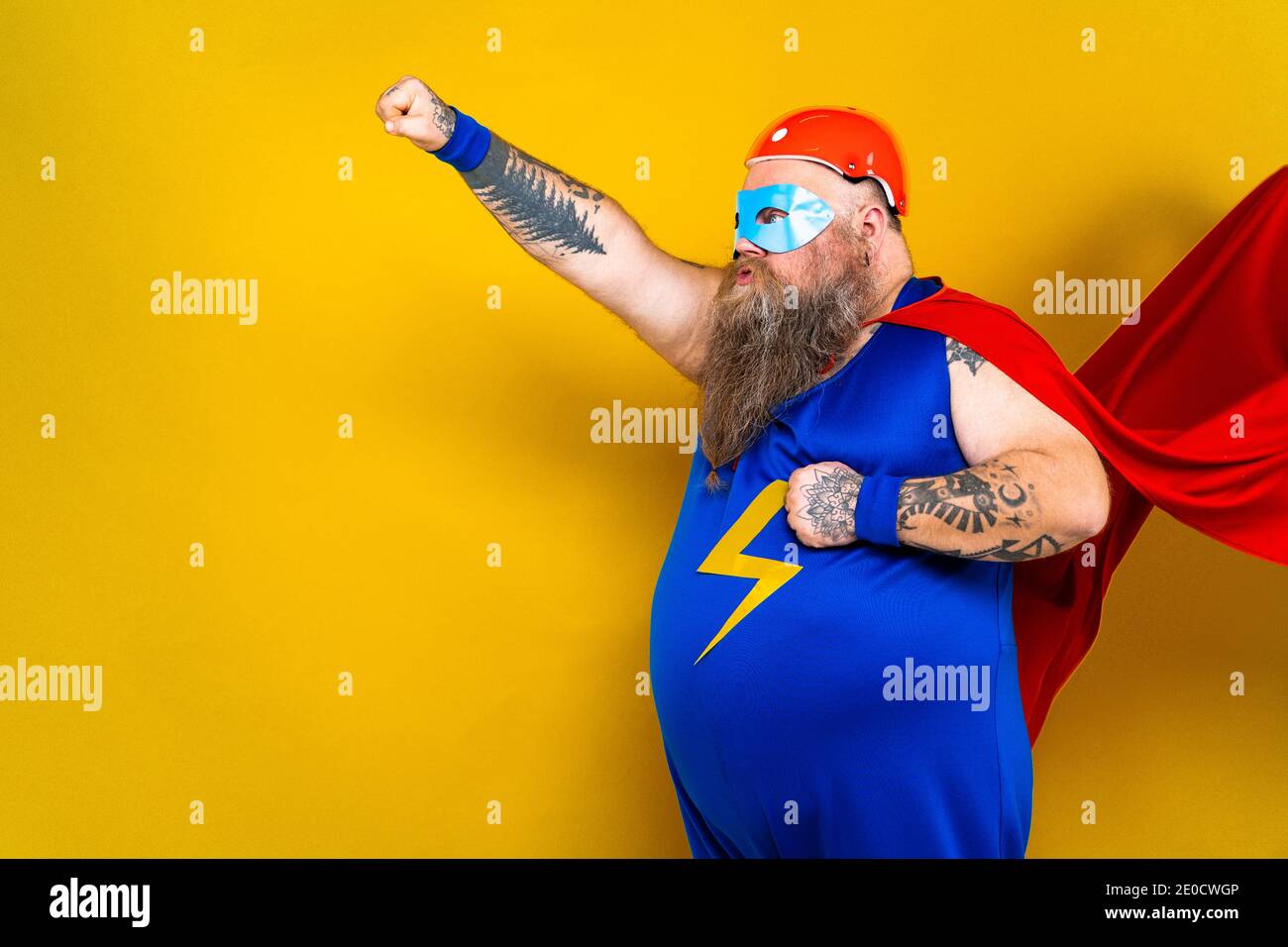Funny fat man with superhero costume acting as superhuman with special ...