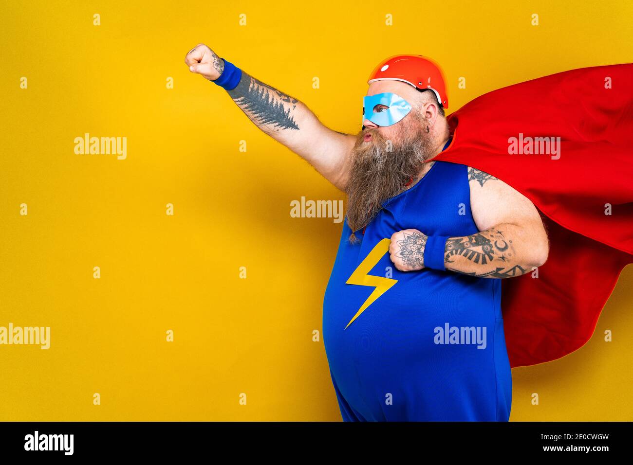 Funny fat man with superhero costume acting as superhuman with special ...