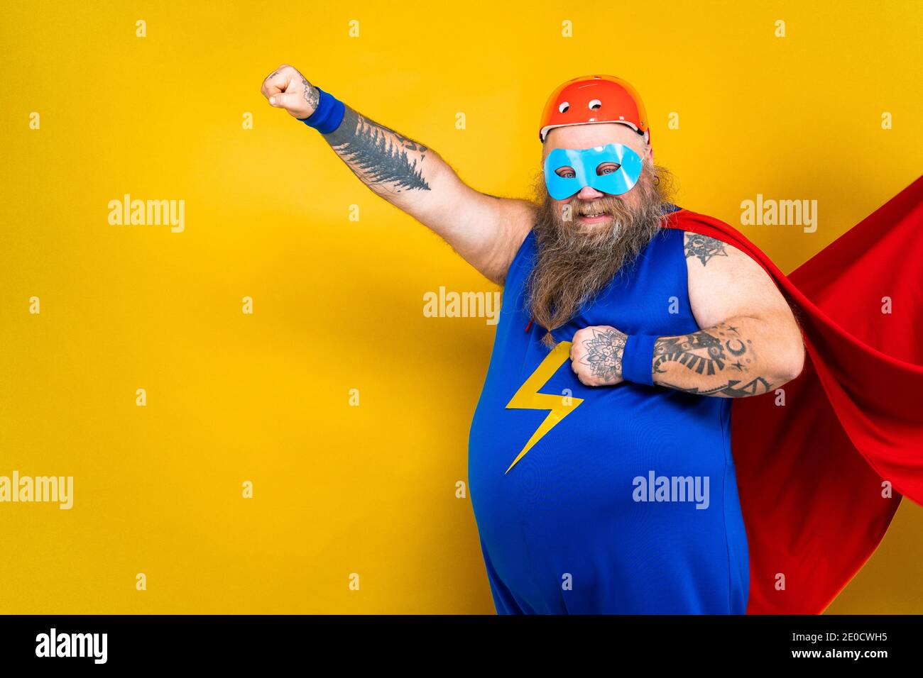Funny fat man with superhero costume acting as superhuman with special ...