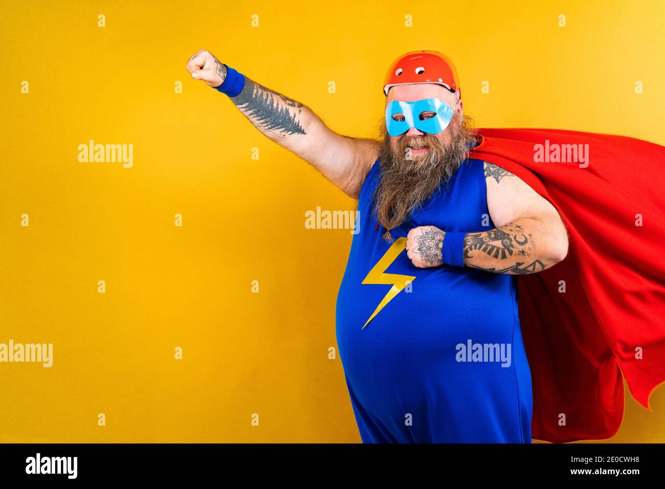 Funny fat man with superhero costume acting as superhuman with special ...