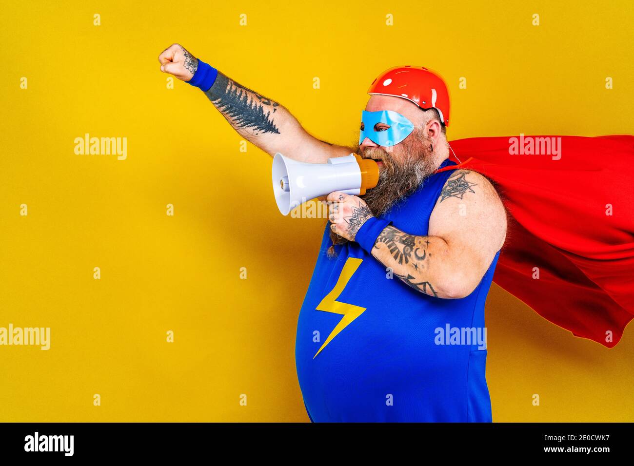 Funny fat man with superhero costume acting as superhuman with special ...
