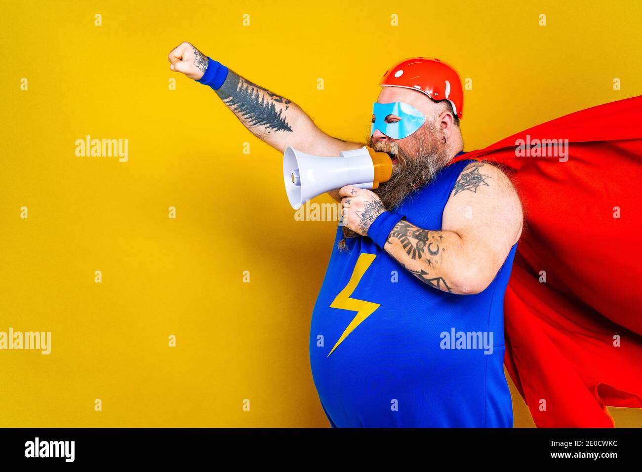 Funny fat man with superhero costume acting as superhuman with special ...