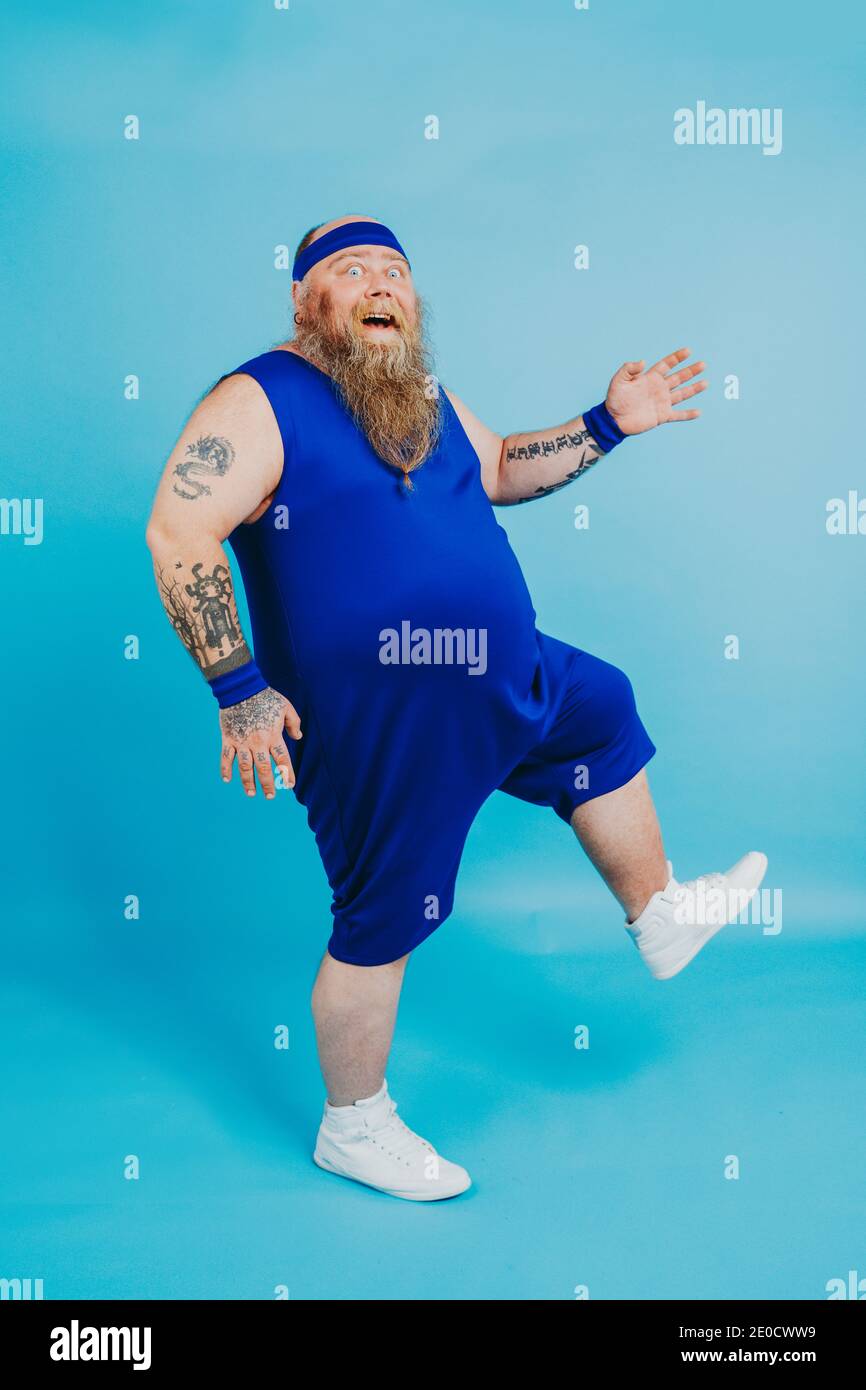 Funny fat man doing some sport exercises - Overweight man having weight ...