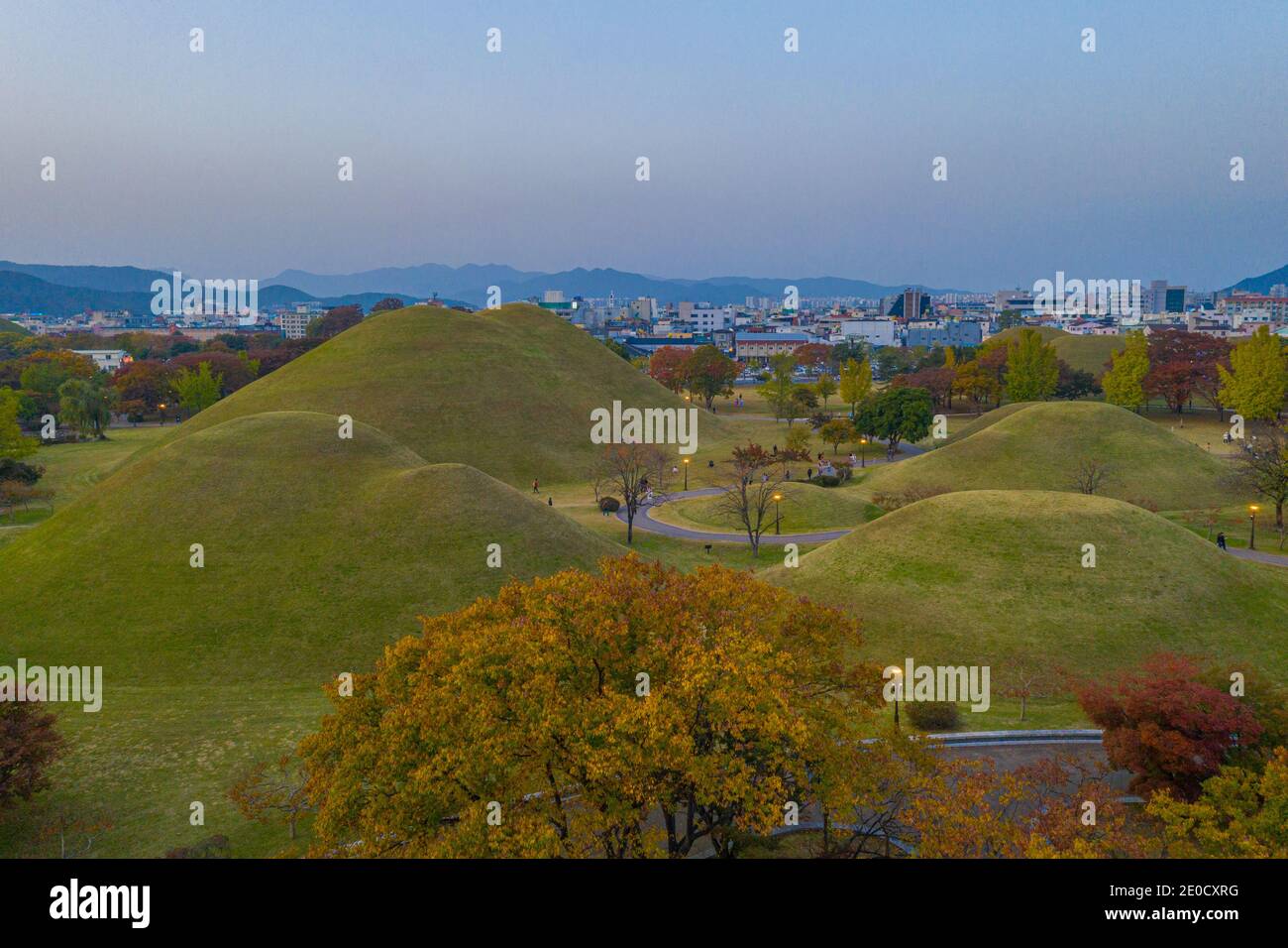 Sunset aerial view of Tumuli park containing several royal tombs in ...