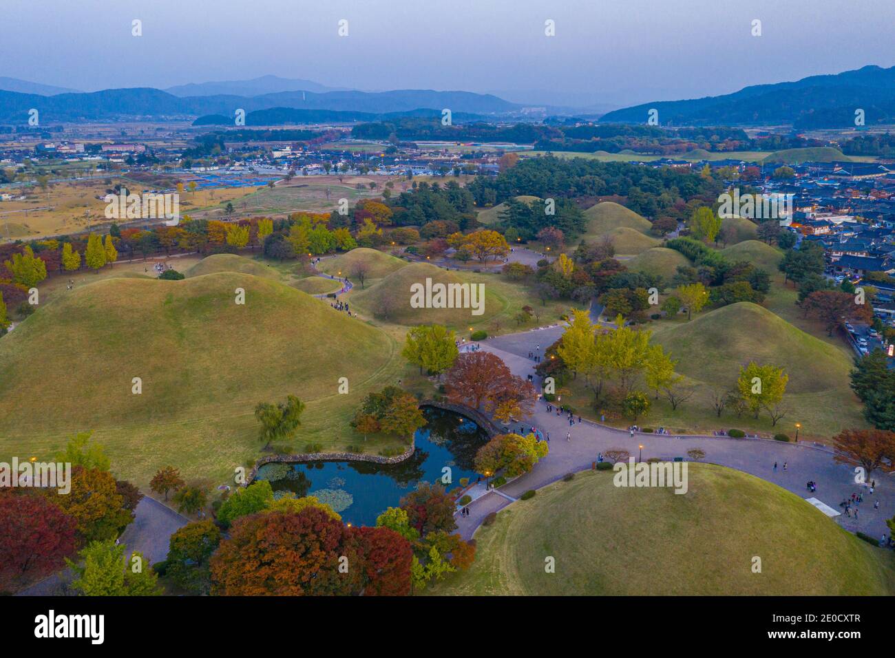 Sunset aerial view of Tumuli park containing several royal tombs in ...