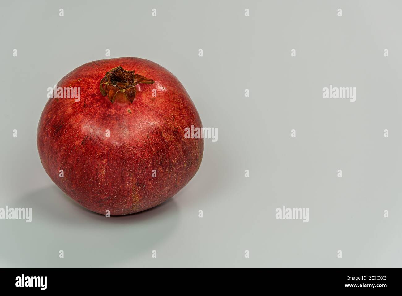 Fresh whole pomegranate against white background. Uncut red fruit ...
